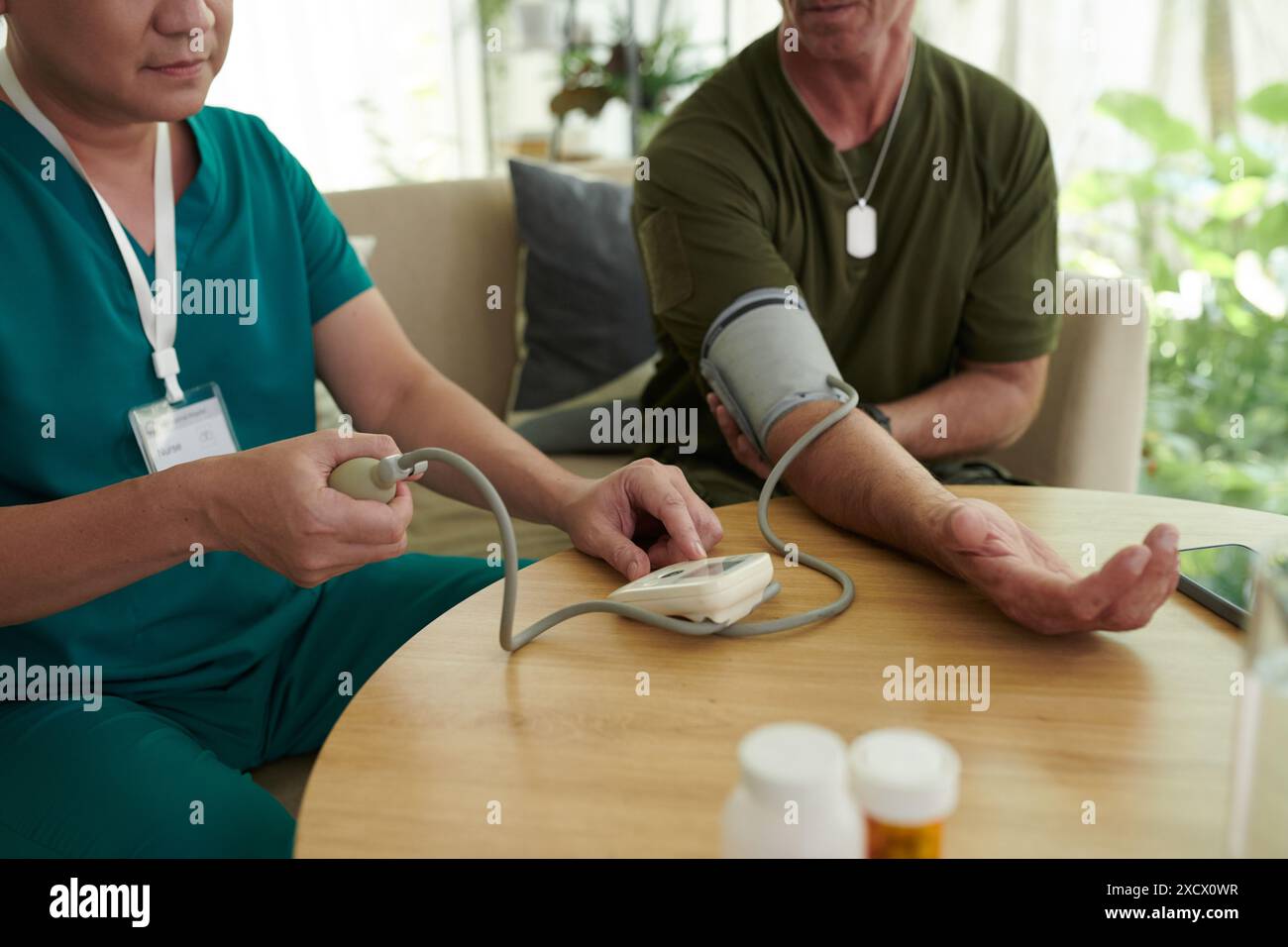 Doctor Measuring Blood Pressure To Soldier Stock Photo - Alamy