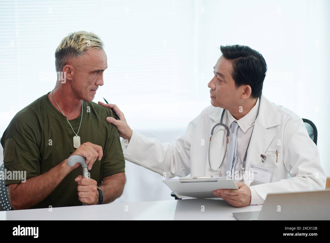 Soldier Having Consultation With Doctor At Hospital Stock Photo - Alamy