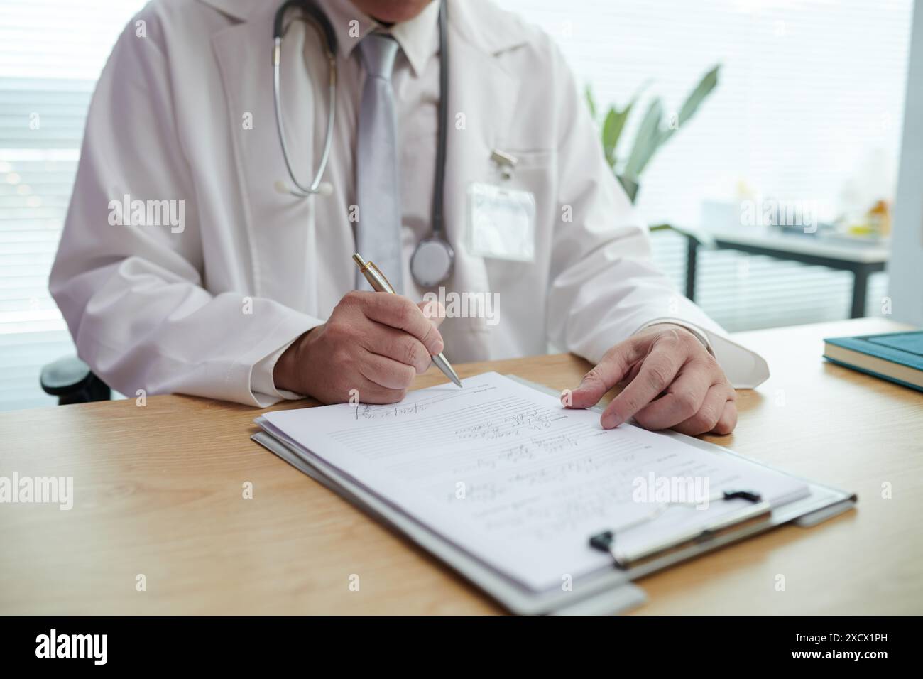 Doctor Writing Prescription in Medical Card Stock Photo - Alamy