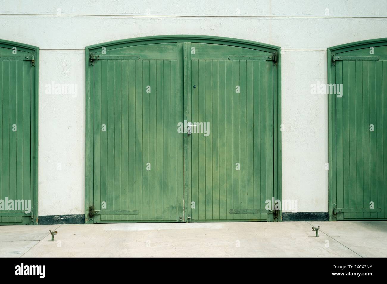 big green wooden doors of old garage building Stock Photo - Alamy
