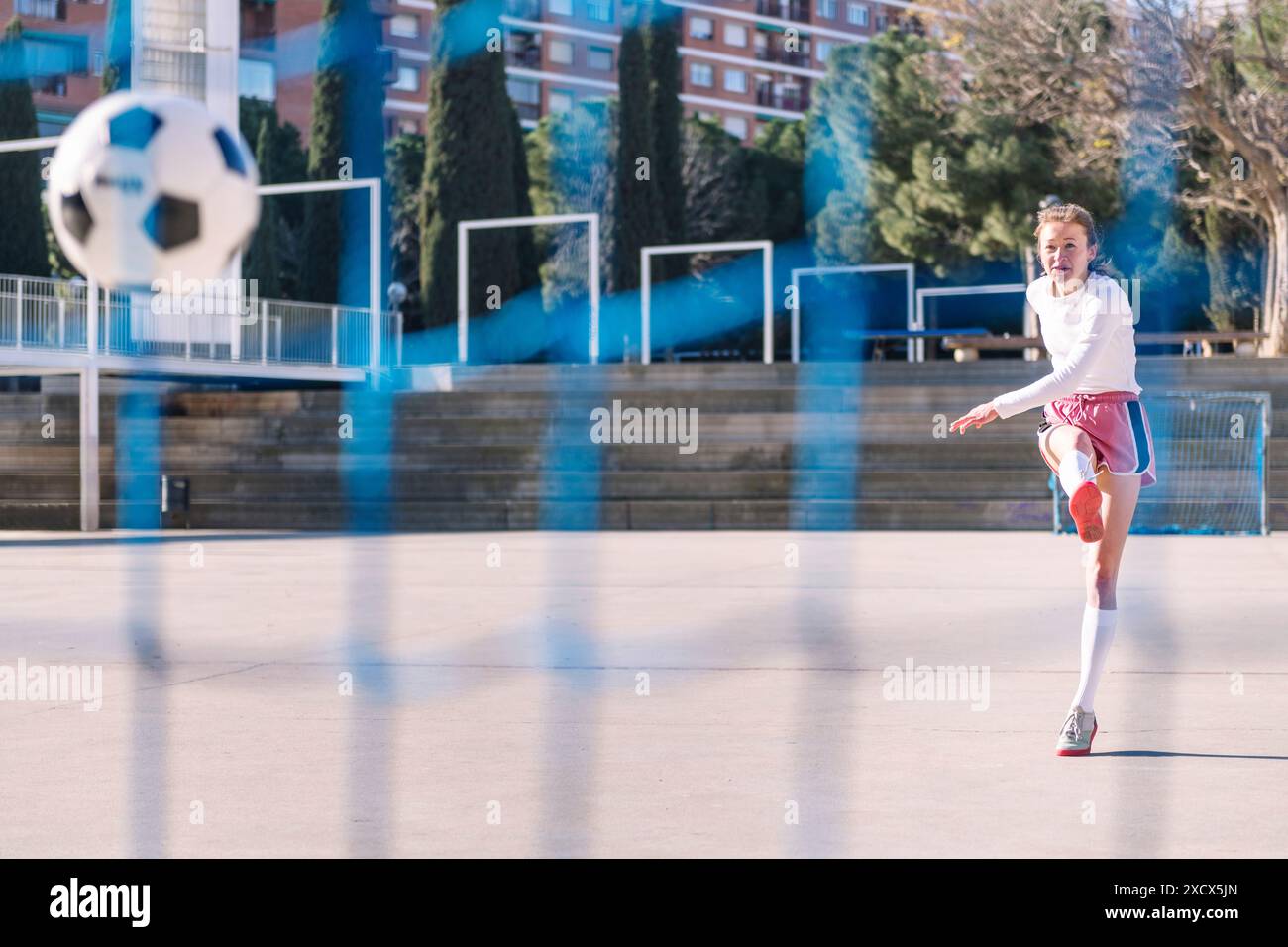female soccer player kicking a ball into the goal Stock Photo - Alamy