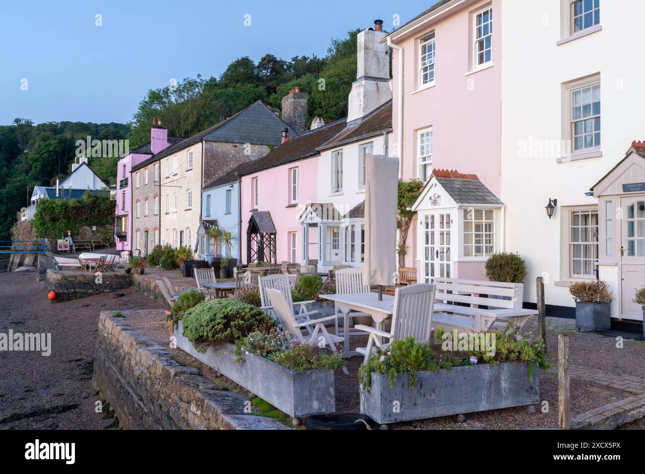 Beautiful old colourful cottages line the riverside village of ...