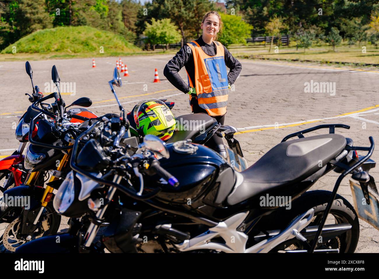 Student showing motorcycle driving license as successfully finished ...