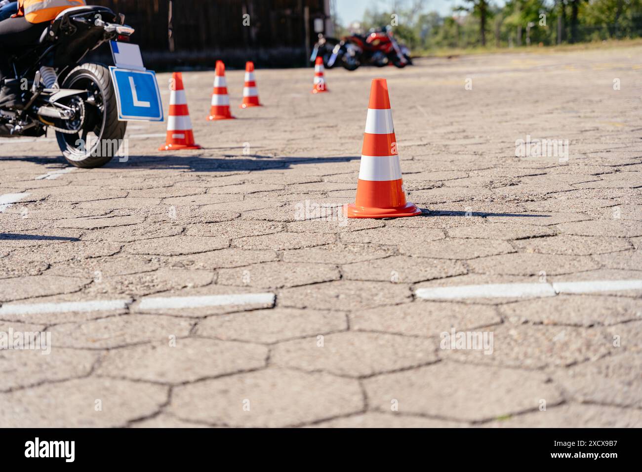 Riding between cones, lesson in motorcycle school Stock Photo - Alamy