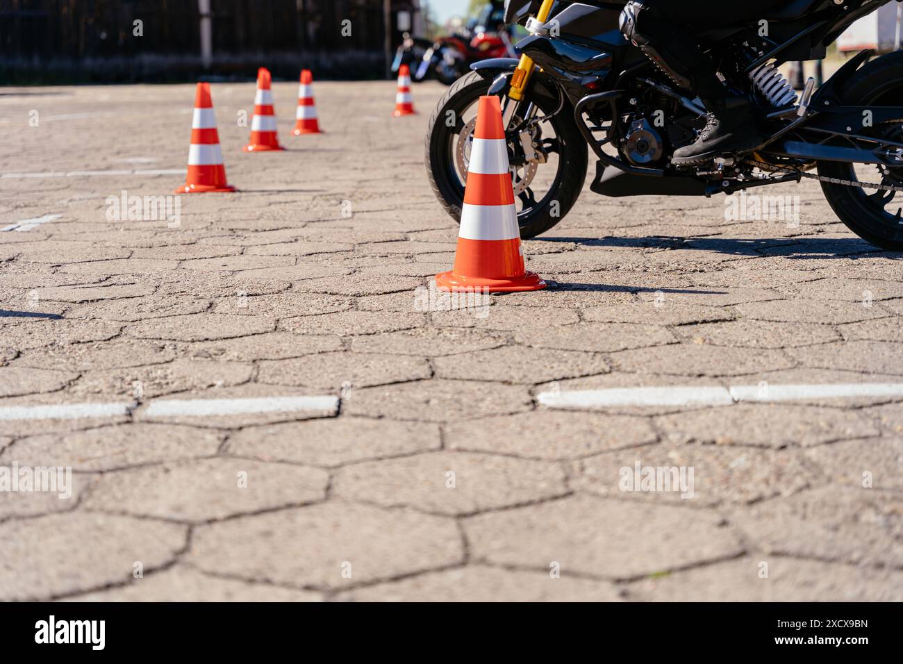 Riding between cones, lesson in motorcycle school Stock Photo - Alamy