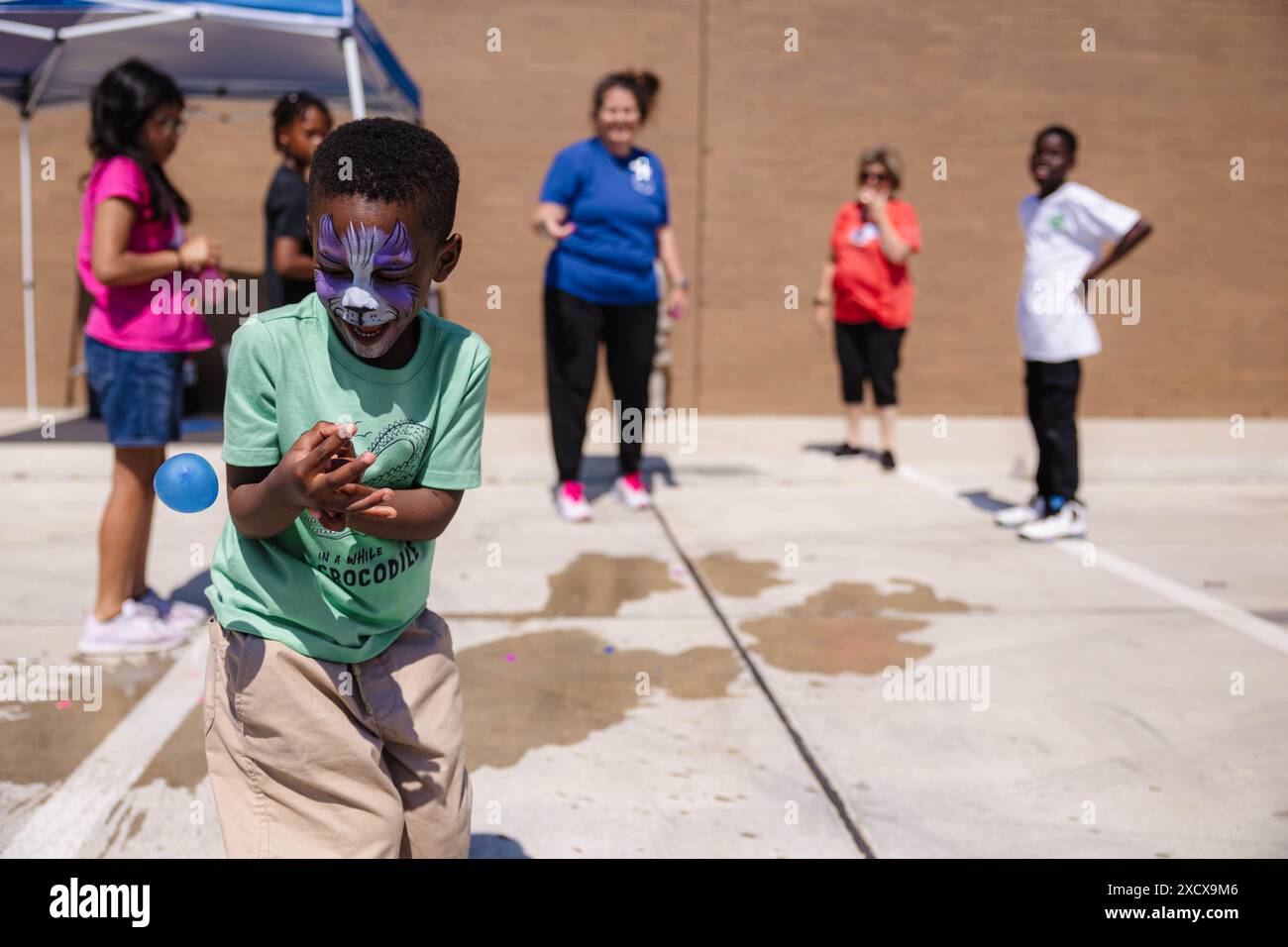 The children playing with water balloons outdoors on Family Field Day ...