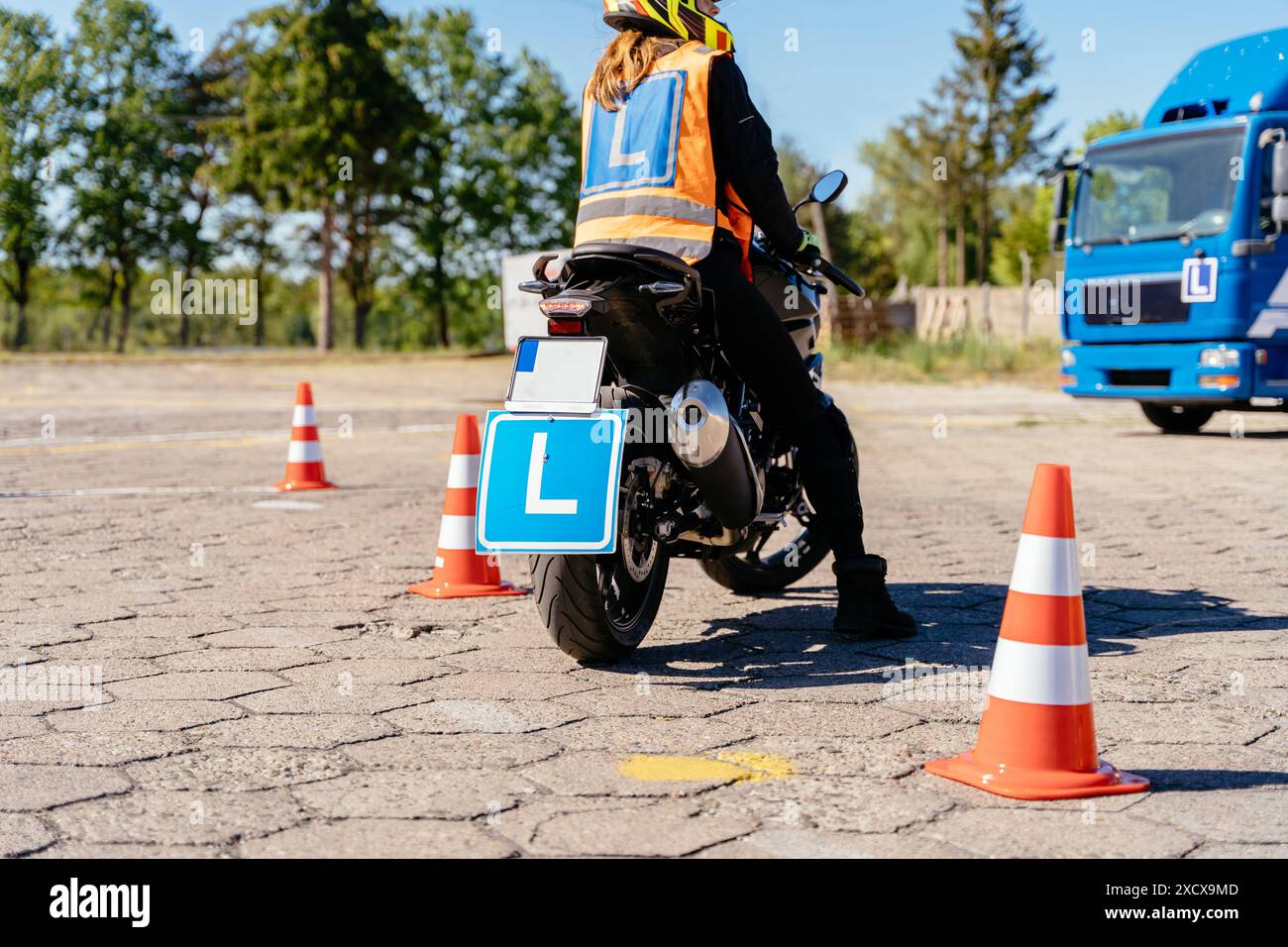 Riding between cones, lesson in motorcycle school Stock Photo - Alamy