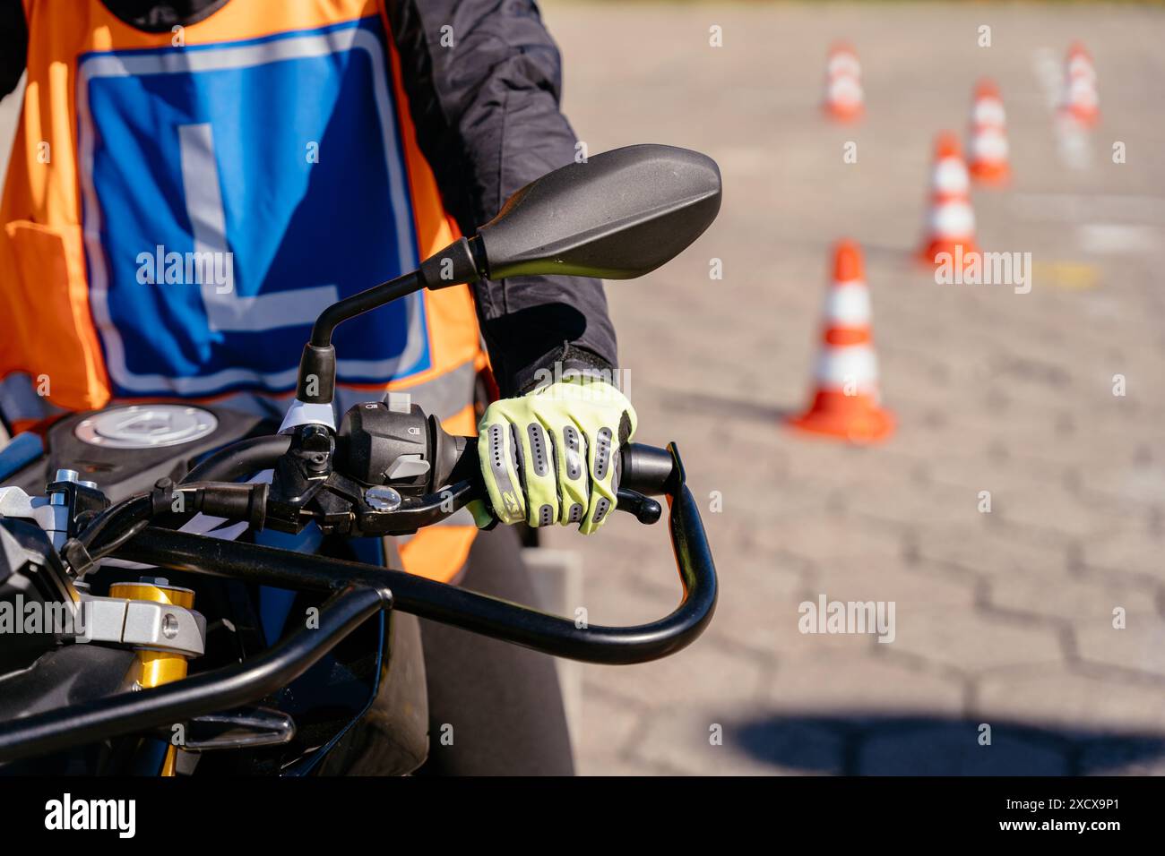Riding between cones, lesson in motorcycle school Stock Photo - Alamy