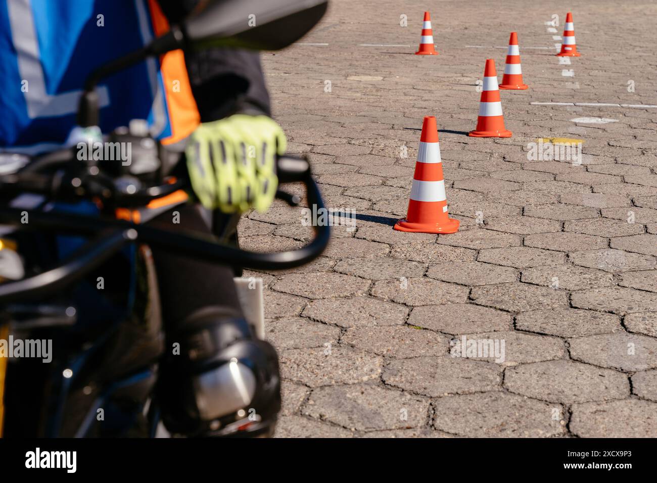 Riding between cones, lesson in motorcycle school Stock Photo - Alamy