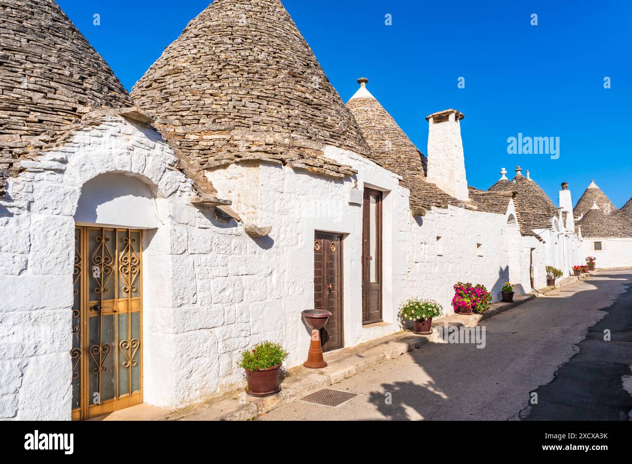 Famous traditional old dry stone trulli houses with conical roofs in ...