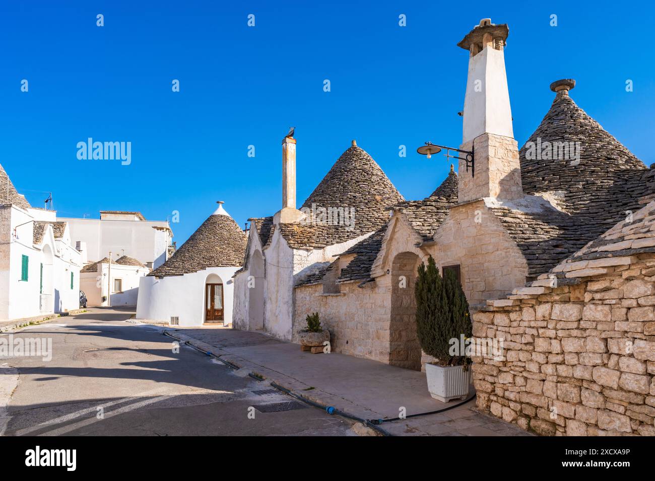 Famous traditional old dry stone trulli houses with conical roofs in ...