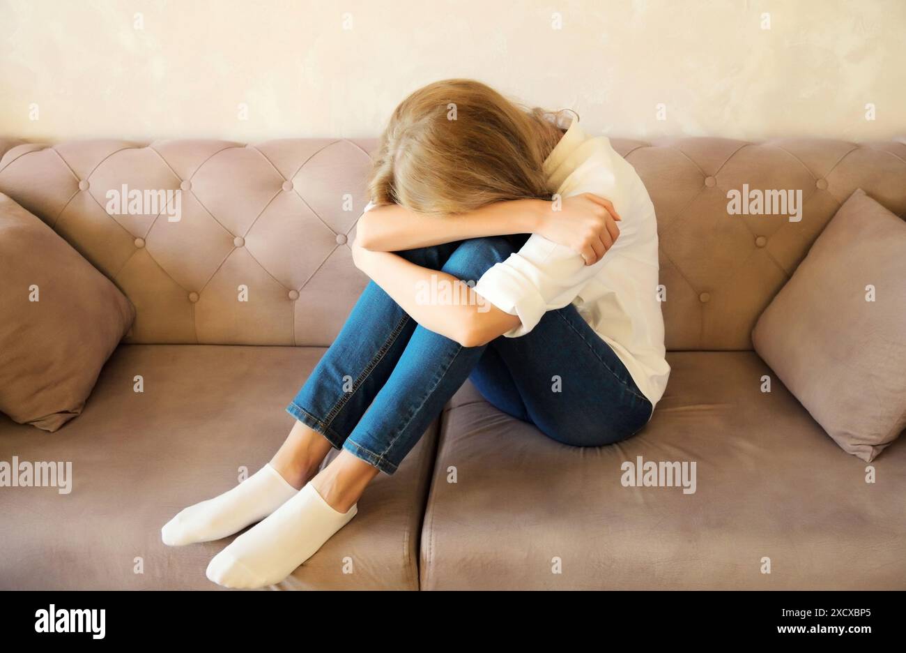 Upset sad crying woman covering her eyes and face with her hands while ...