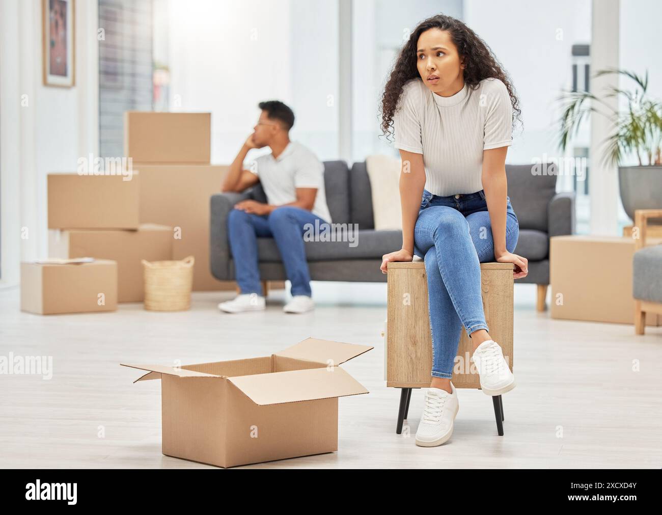 Couple, unhappy and woman worry with box for moving stress, lost items ...