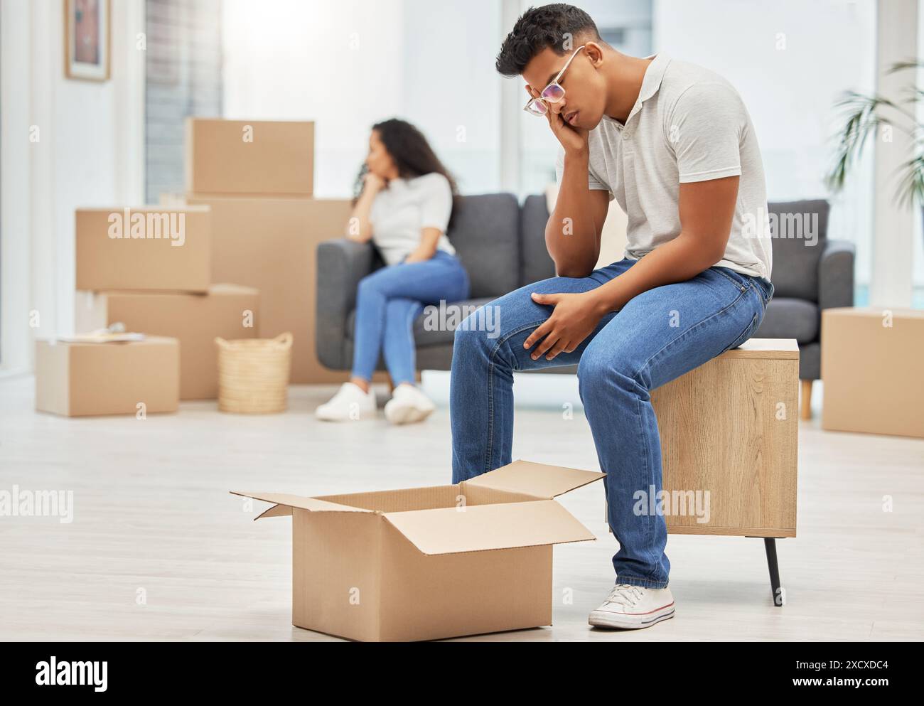 Couple, unhappy and man worry with box for moving stress, lost items ...