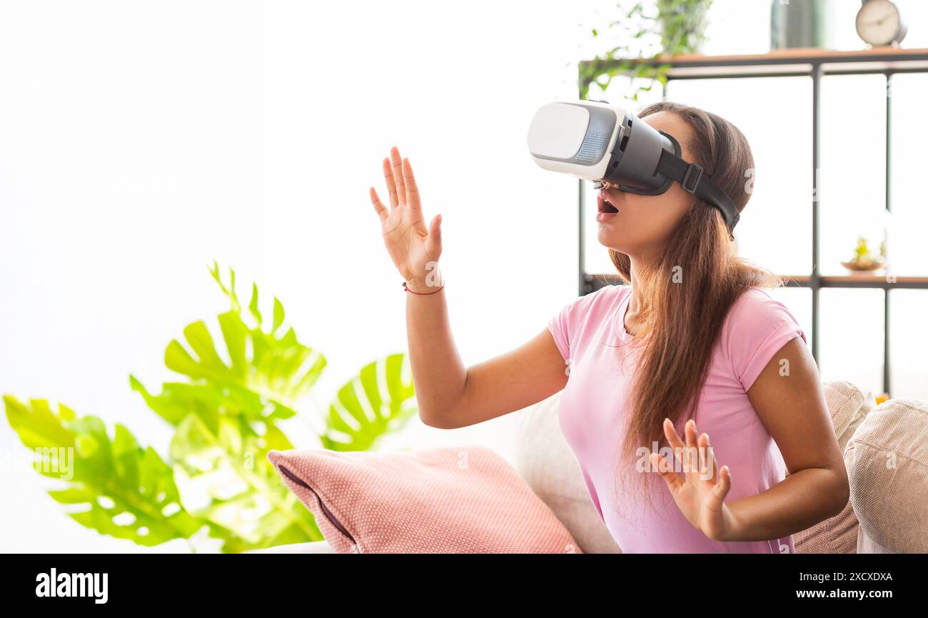 Girl Experiencing Virtual Reality While Sitting on a Couch Stock Photo ...