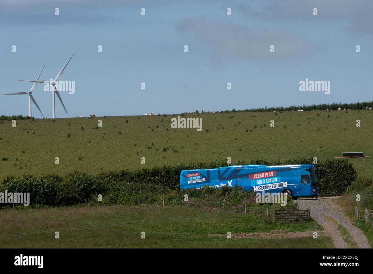 Conservative party battle bus and wind turbines Stock Photo - Alamy
