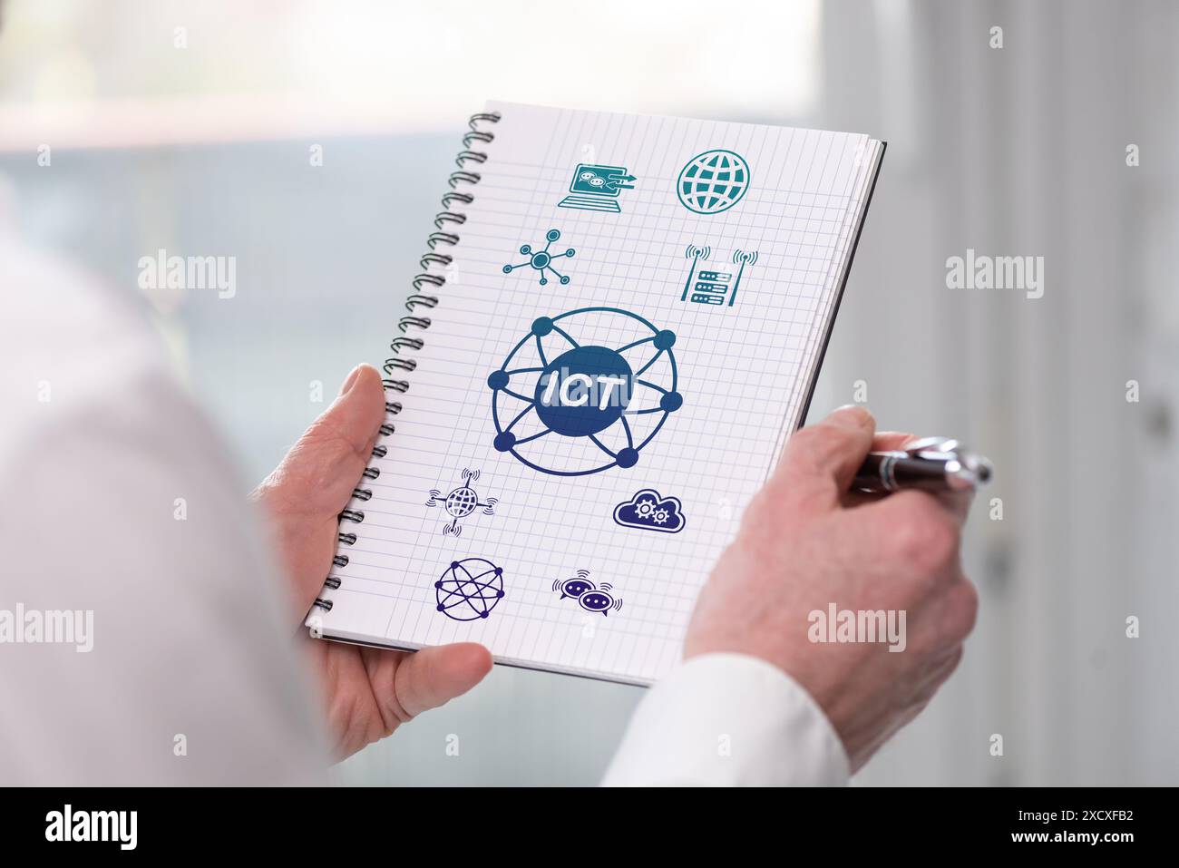 Hand holding a notepad with ict concept Stock Photo - Alamy
