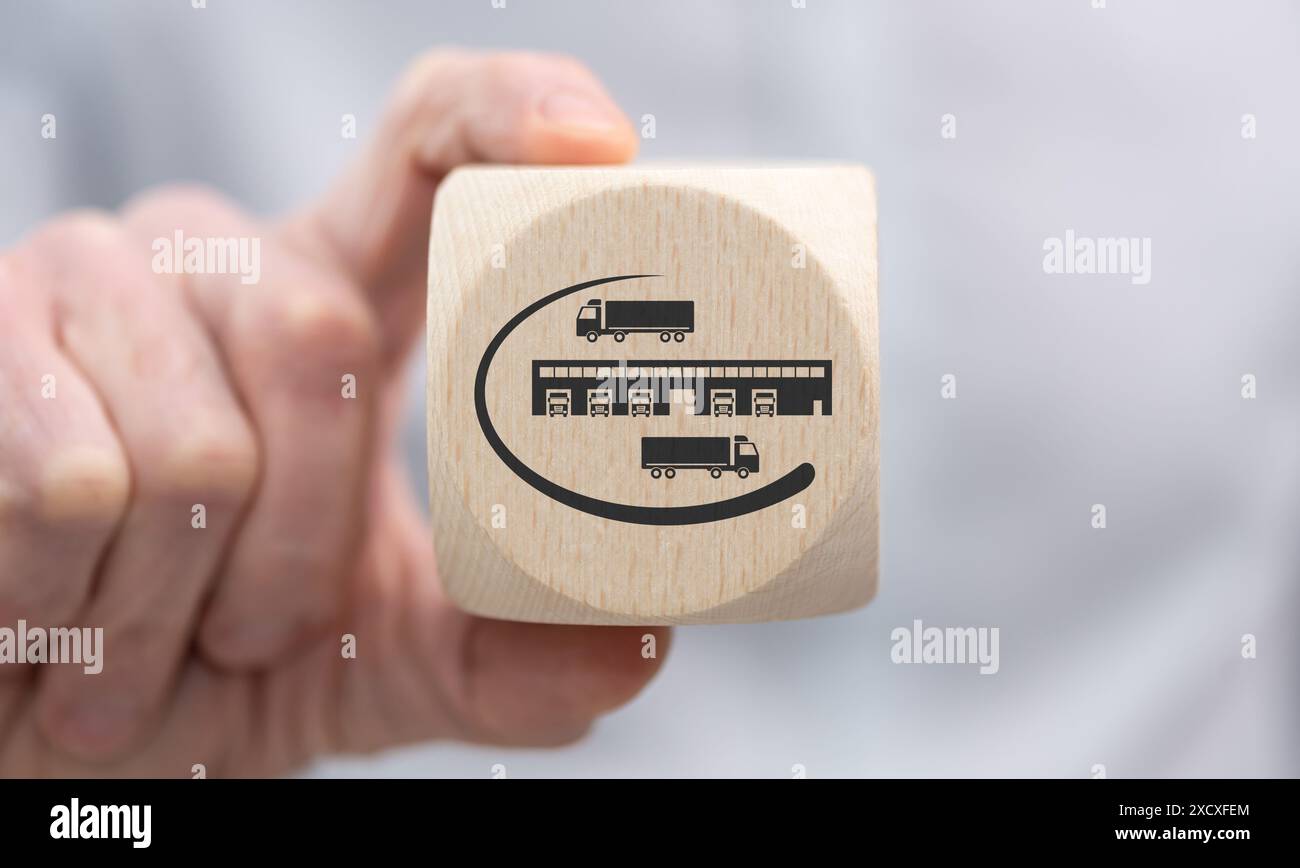Hand holding a wooden cube with symbol of logistics concept Stock Photo ...