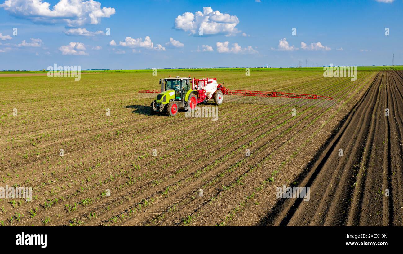 Above view on tractor until spraying farmland, dragging mounted wide ...