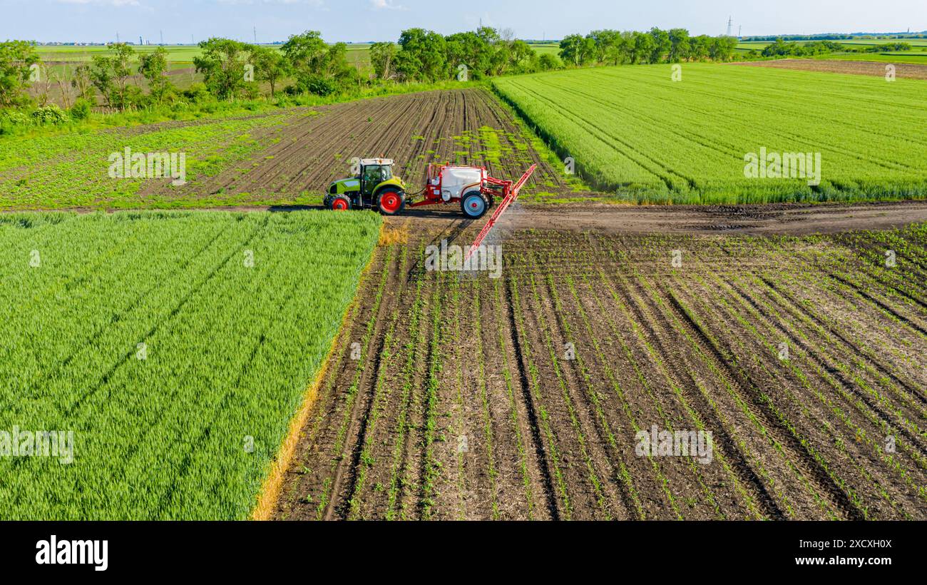 Above view on tractor until spraying farmland, dragging mounted wide ...