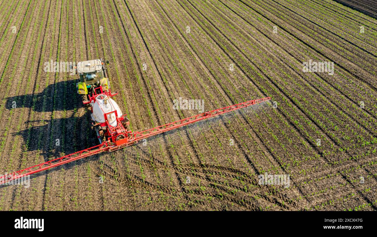 Above view on tractor until spraying farmland, dragging mounted wide ...