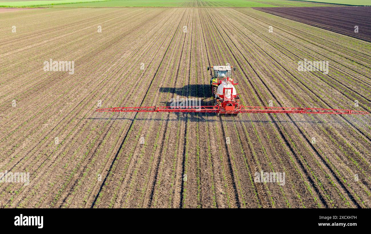 Above view on tractor until spraying farmland, dragging mounted wide ...