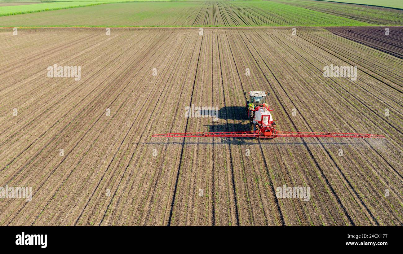 Above view on tractor until spraying farmland, dragging mounted wide ...