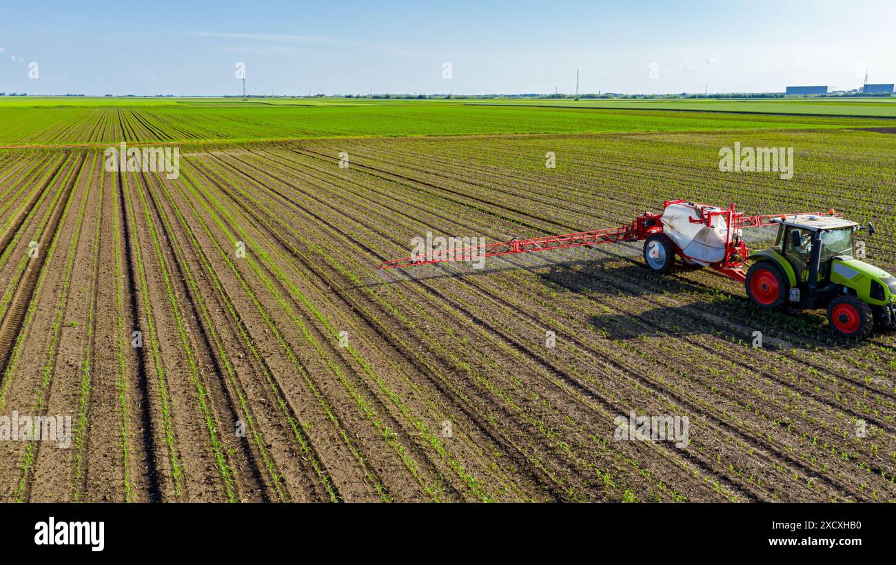 Above view on tractor until spraying farmland, dragging mounted wide ...