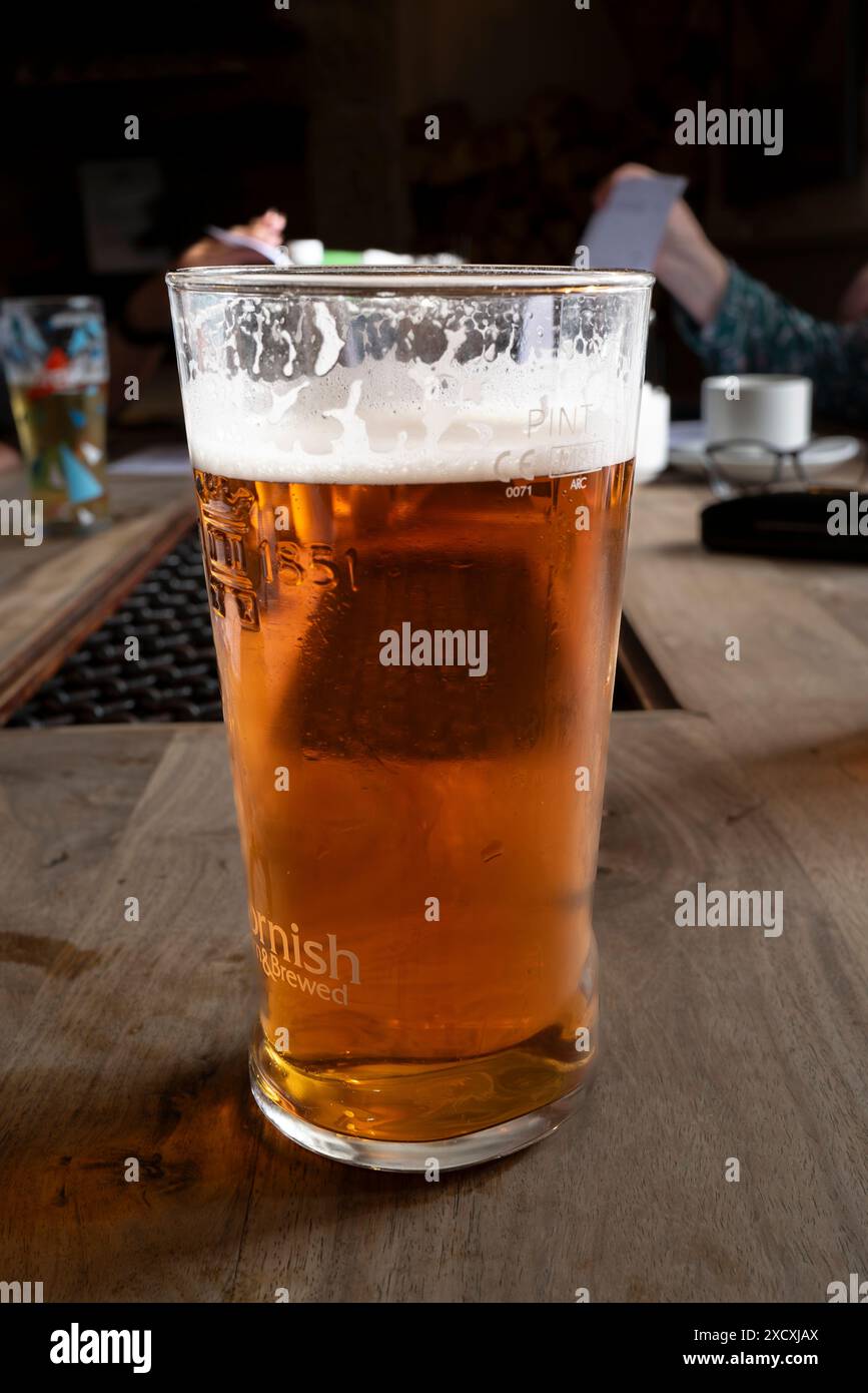 A pint of bitter beer on a table in a pub public house in Cornwall in ...
