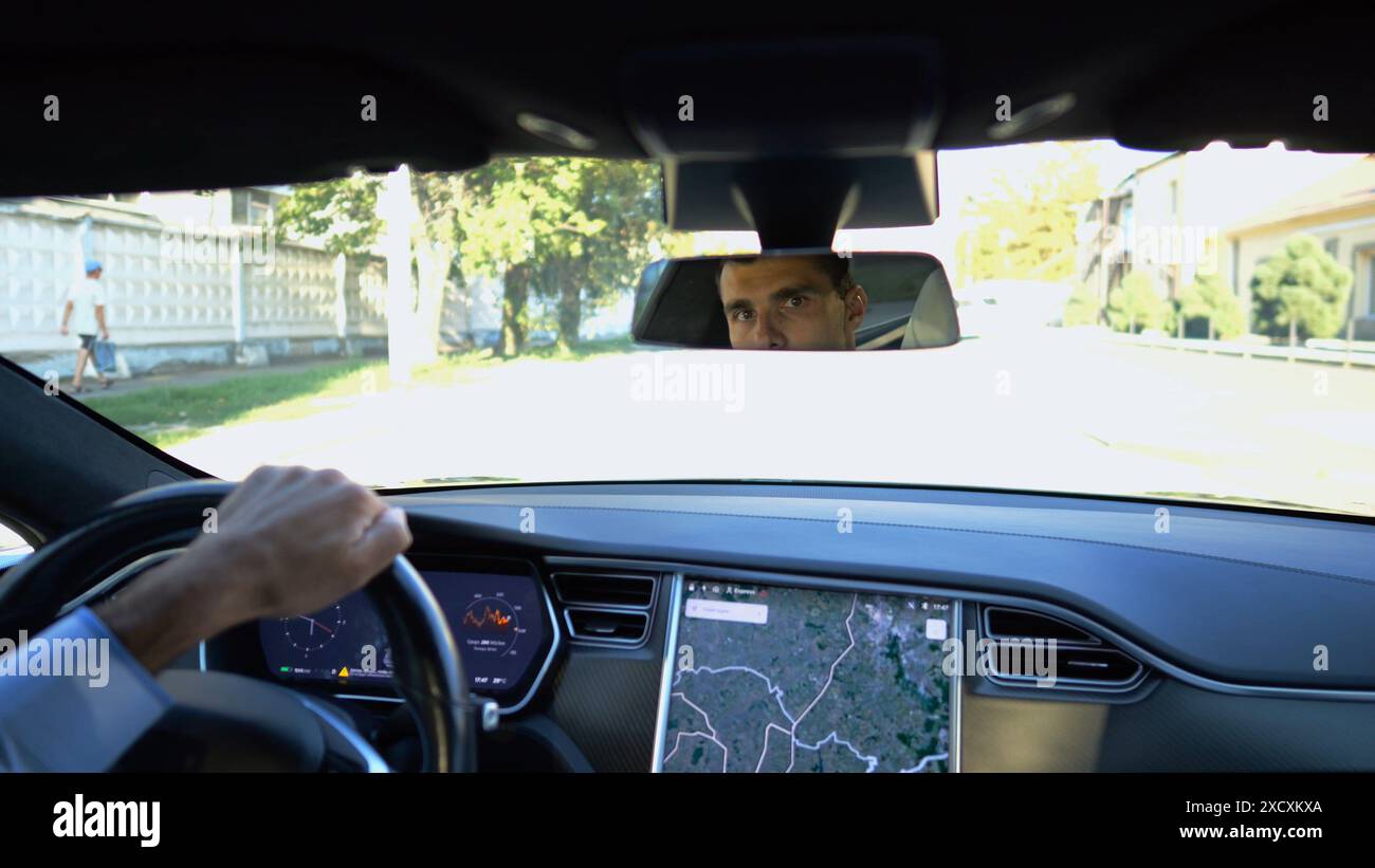 Eyes of male driver reflecting of rearview mirror during riding ...