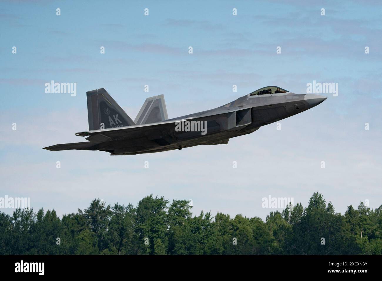 A U.S. Air Force F-22 Raptor assigned to the 3rd Wing takes off above ...