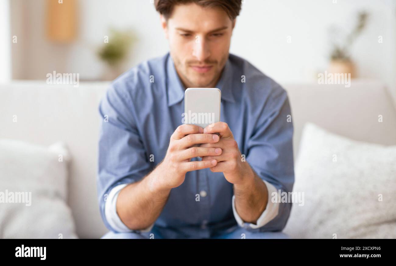 Man using smartphone indoors hi-res stock photography and images - Alamy