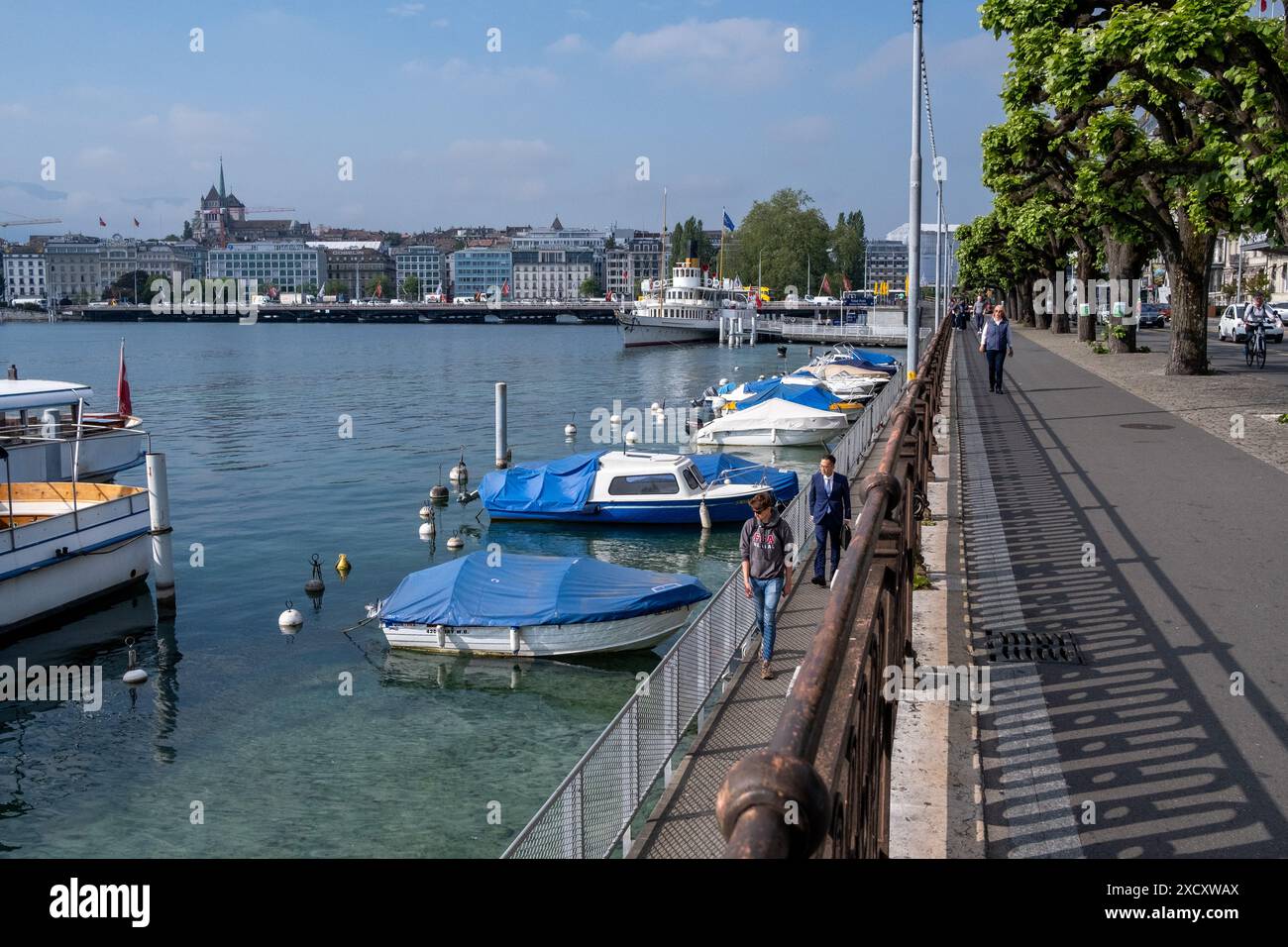 Passenger and boat on the shores of Lake Leman with Saint-Pierre ...
