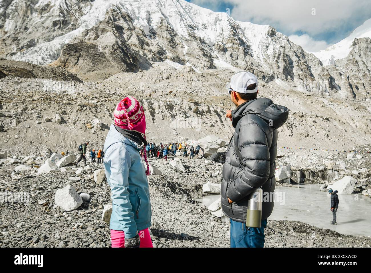 Nepalese male guide and tourist woman on Everest base camp trek ...