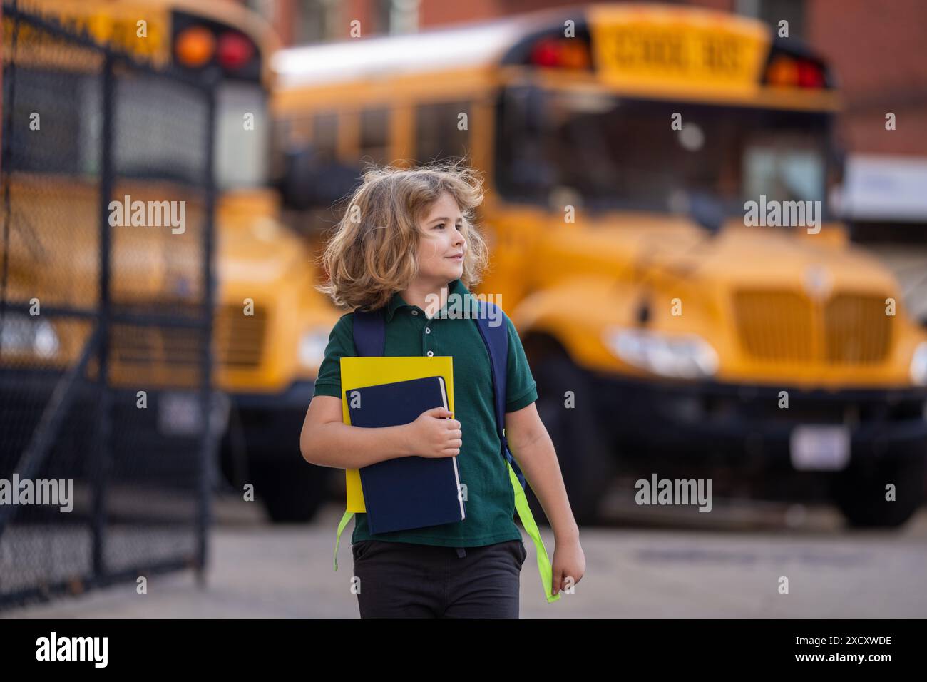Schoolkid getting on the school bus. American School. Back to school ...