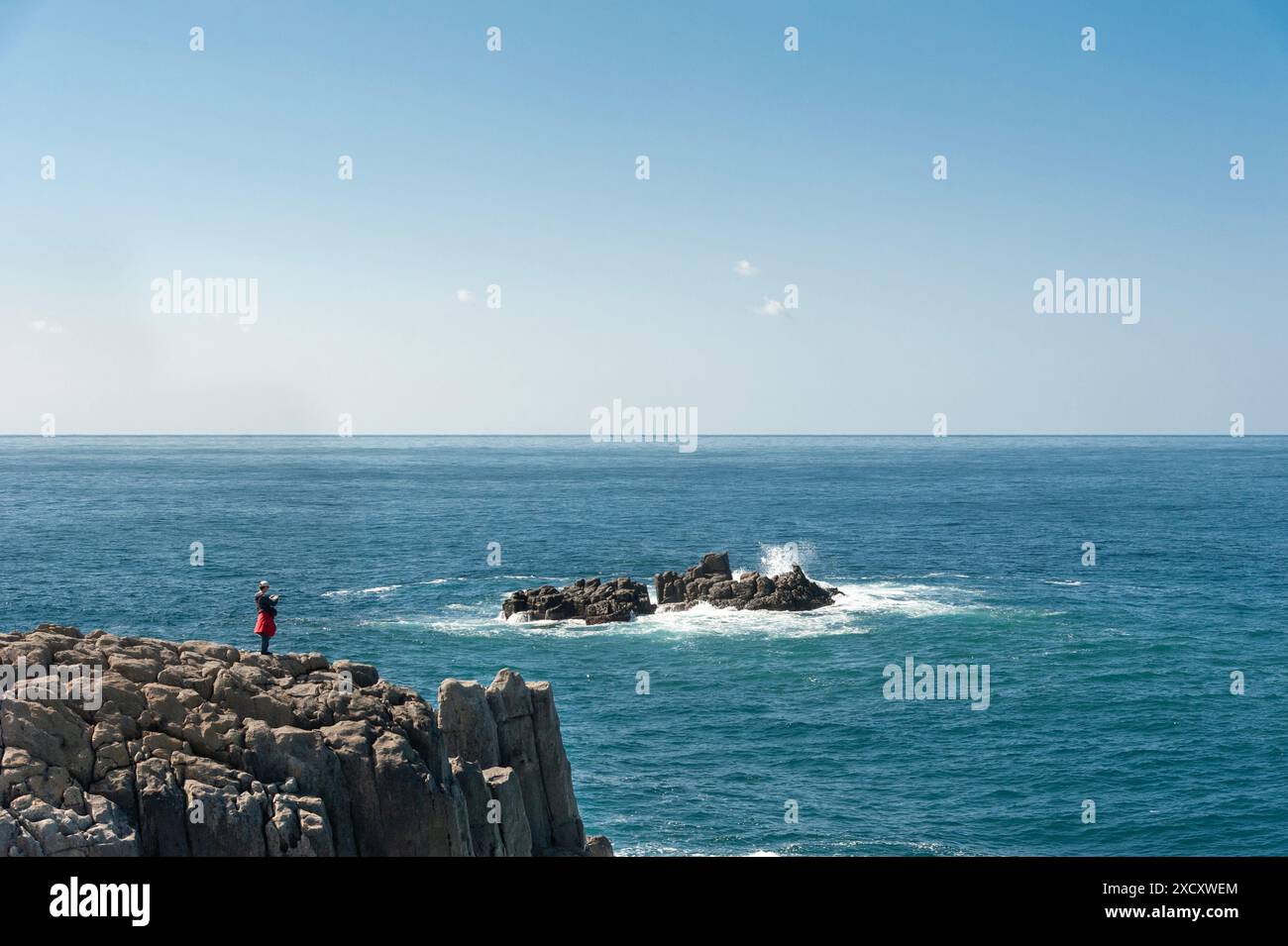 A tourist takes in the spectacular view of the Sea of Japan from the ...