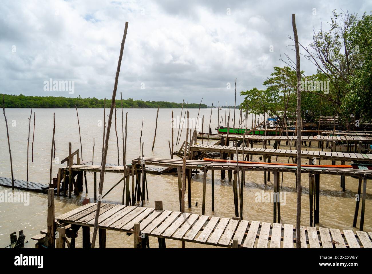 Piers with small fisher boats in Nickerie river, Suriname Stock Photo ...
