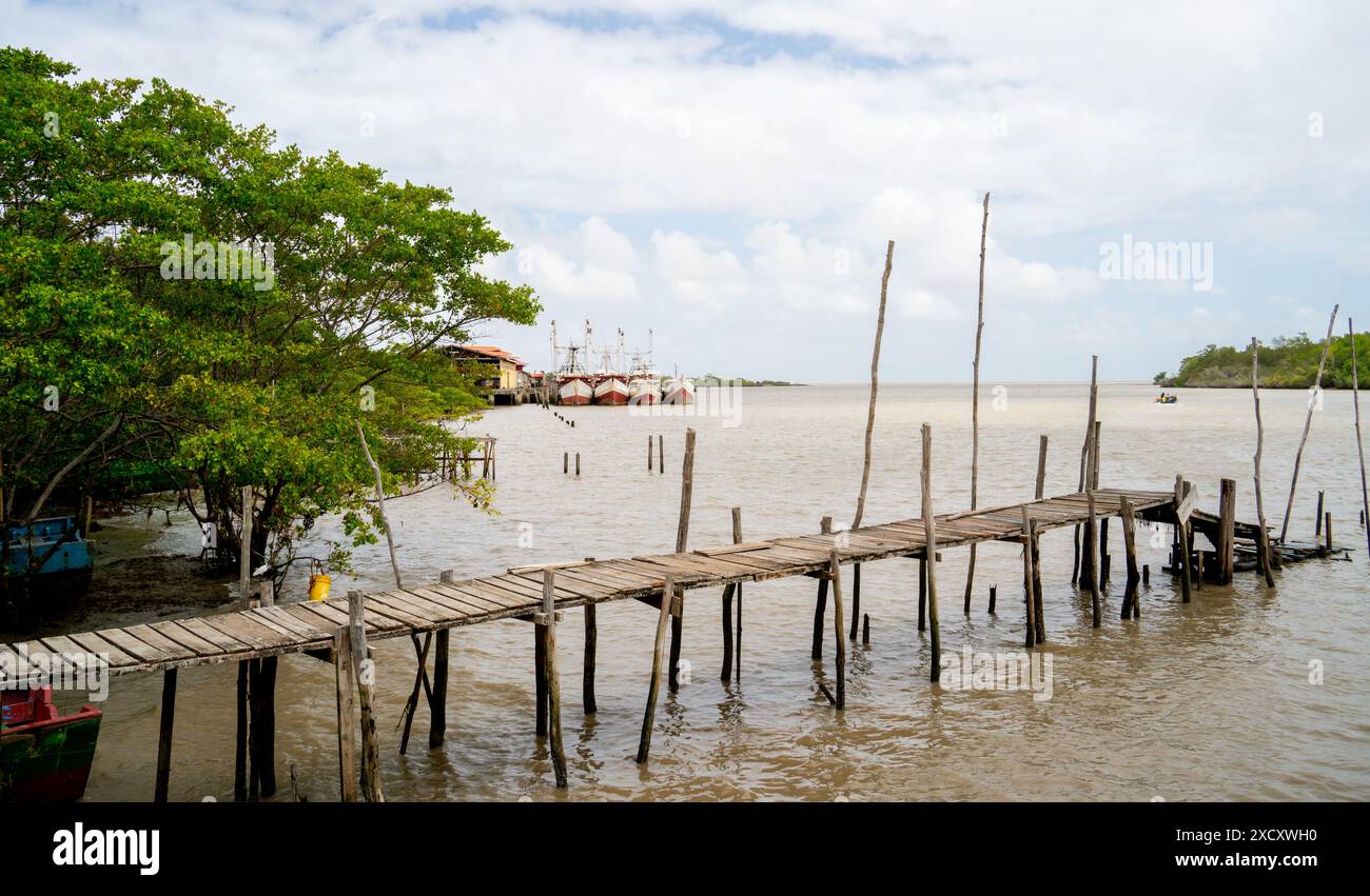 Piers with small fisher boats in Nickerie river, Suriname Stock Photo ...