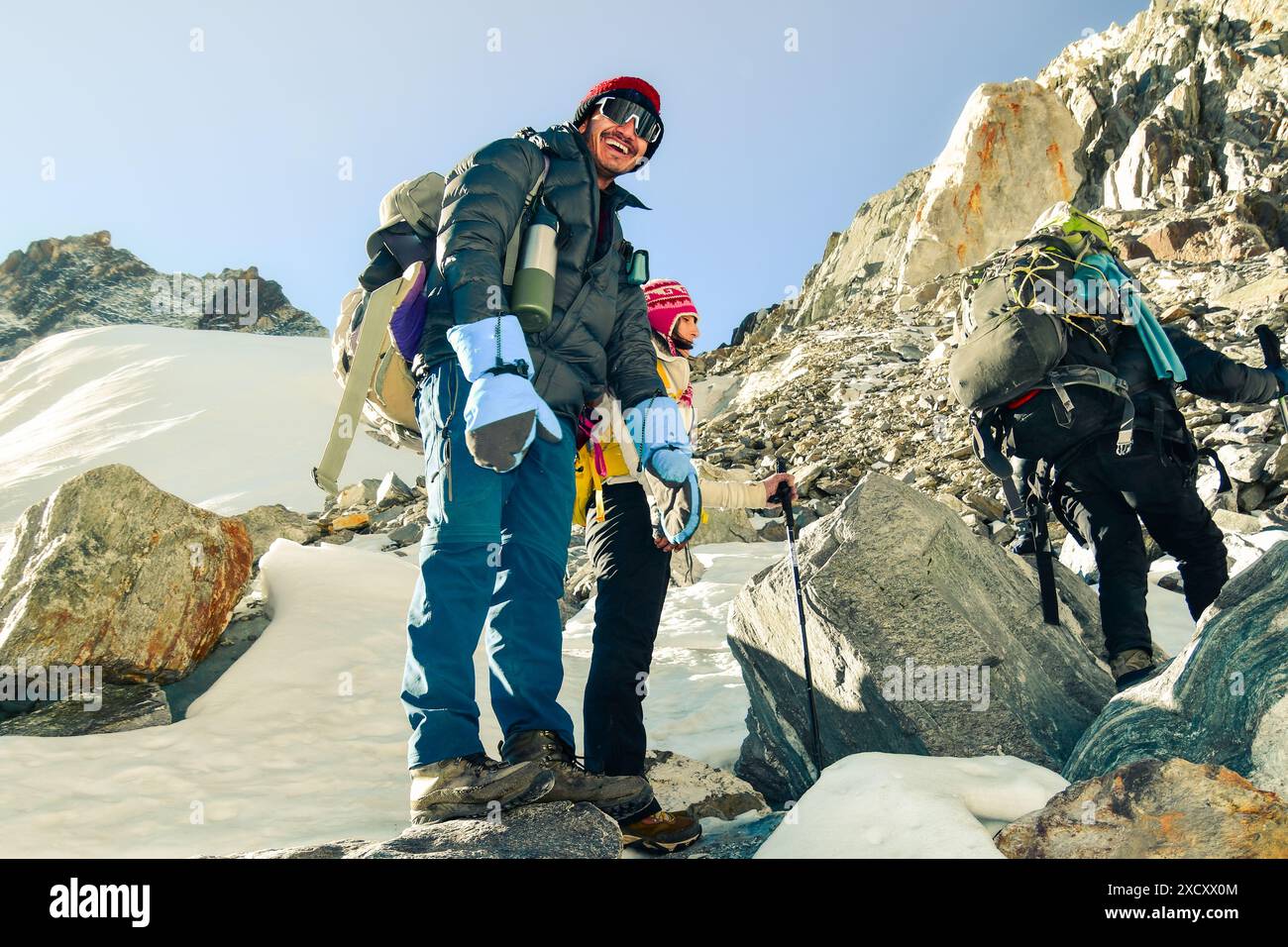 Male sherpa guide and caucasian tourist woman together cross mountain ...
