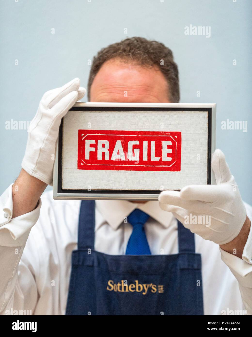 London, UK. 19 June 2024. A technician presents 'Fragile' by Andy Warhol (Est. £100,000 ...