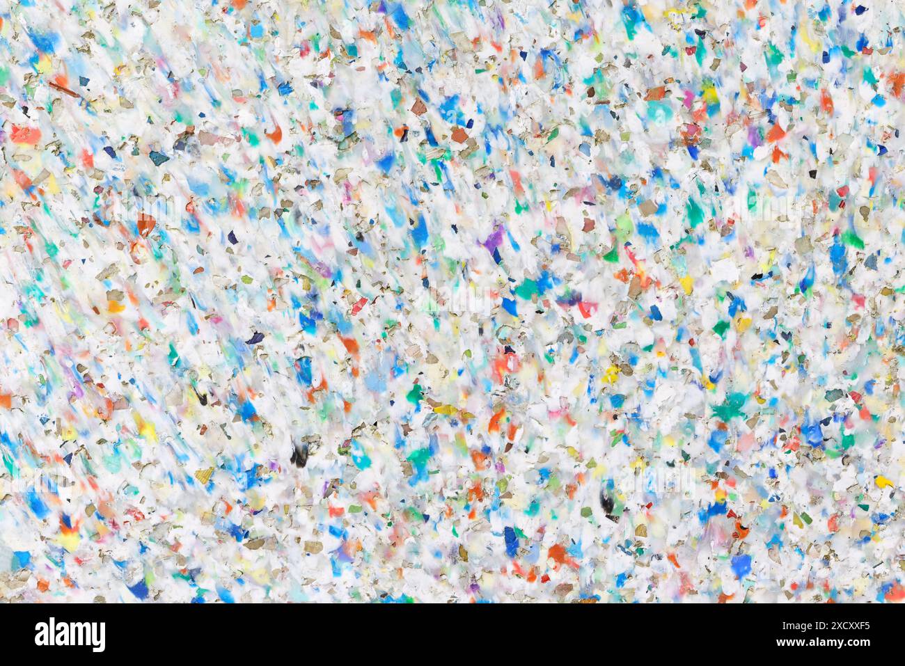 colourful texture of a board made of conglomerated plastic waste ...