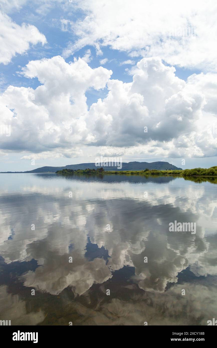 Clouds reflecting on the calm waters of Loch Leven with Benarty Hill in ...
