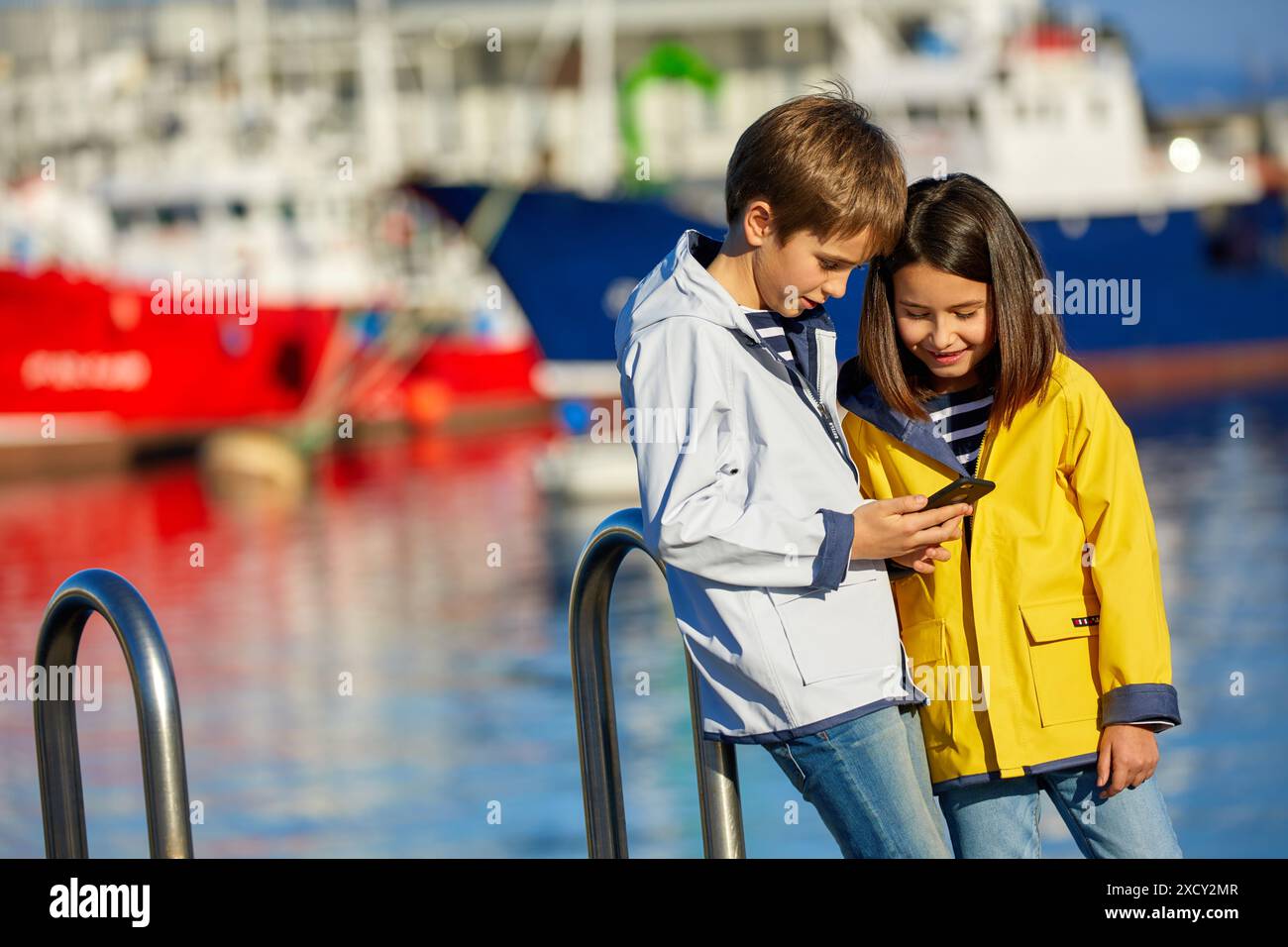 Children with raincoat, Port of Getaria, Gipuzkoa, Basque Country ...