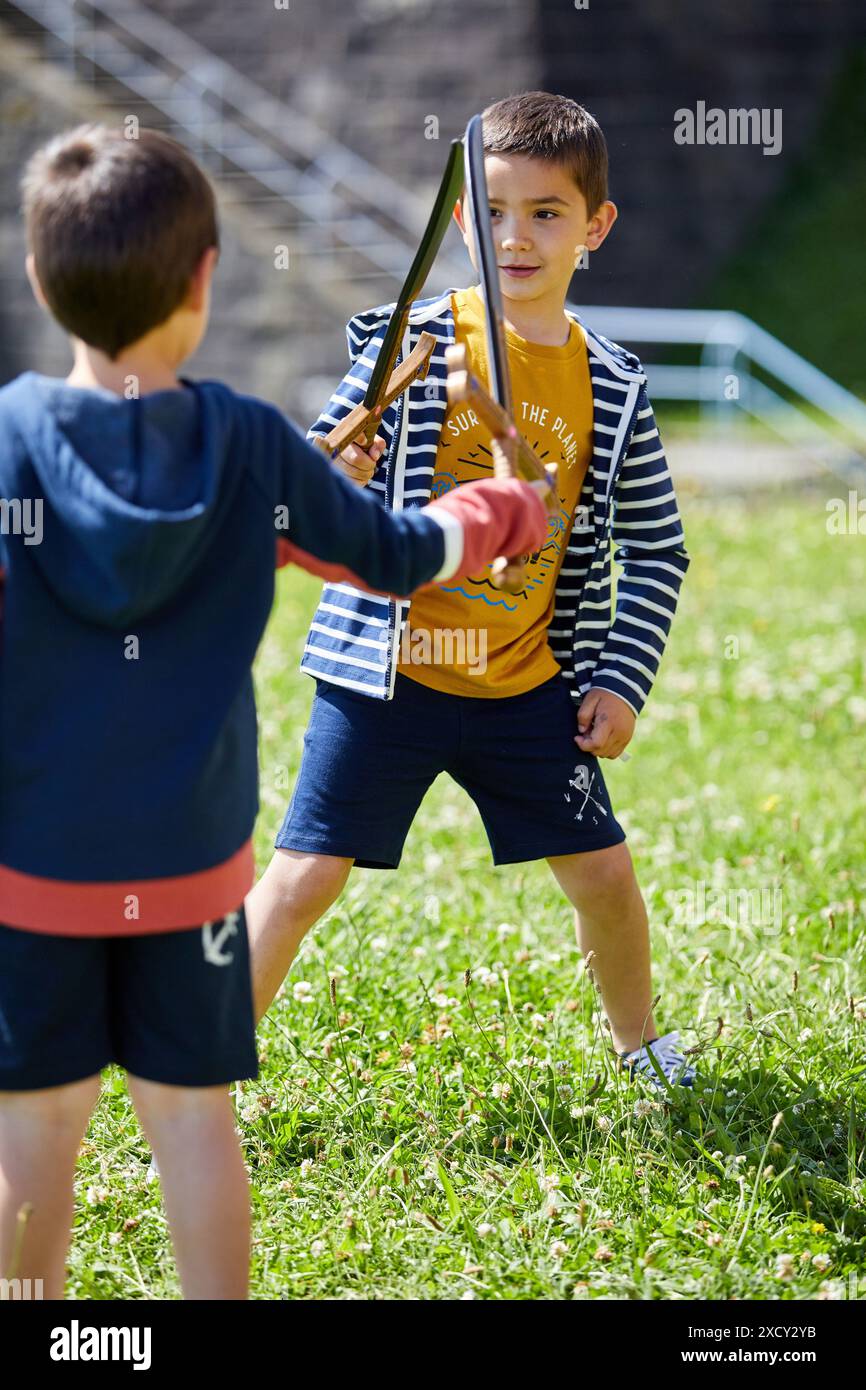 Two boys playing with swords hi-res stock photography and images - Alamy