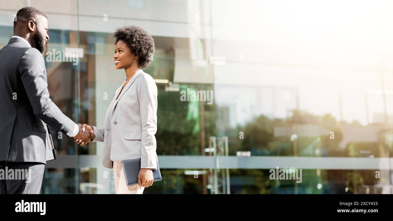 Nice to meet you. Two african business people introducing outdoors ...