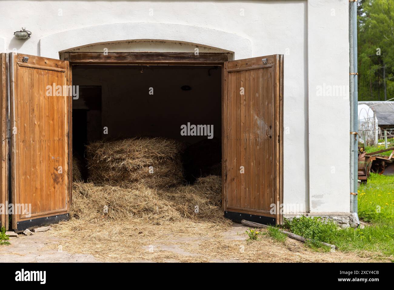 Open wooden barn gate with hay storage inside Stock Photo - Alamy