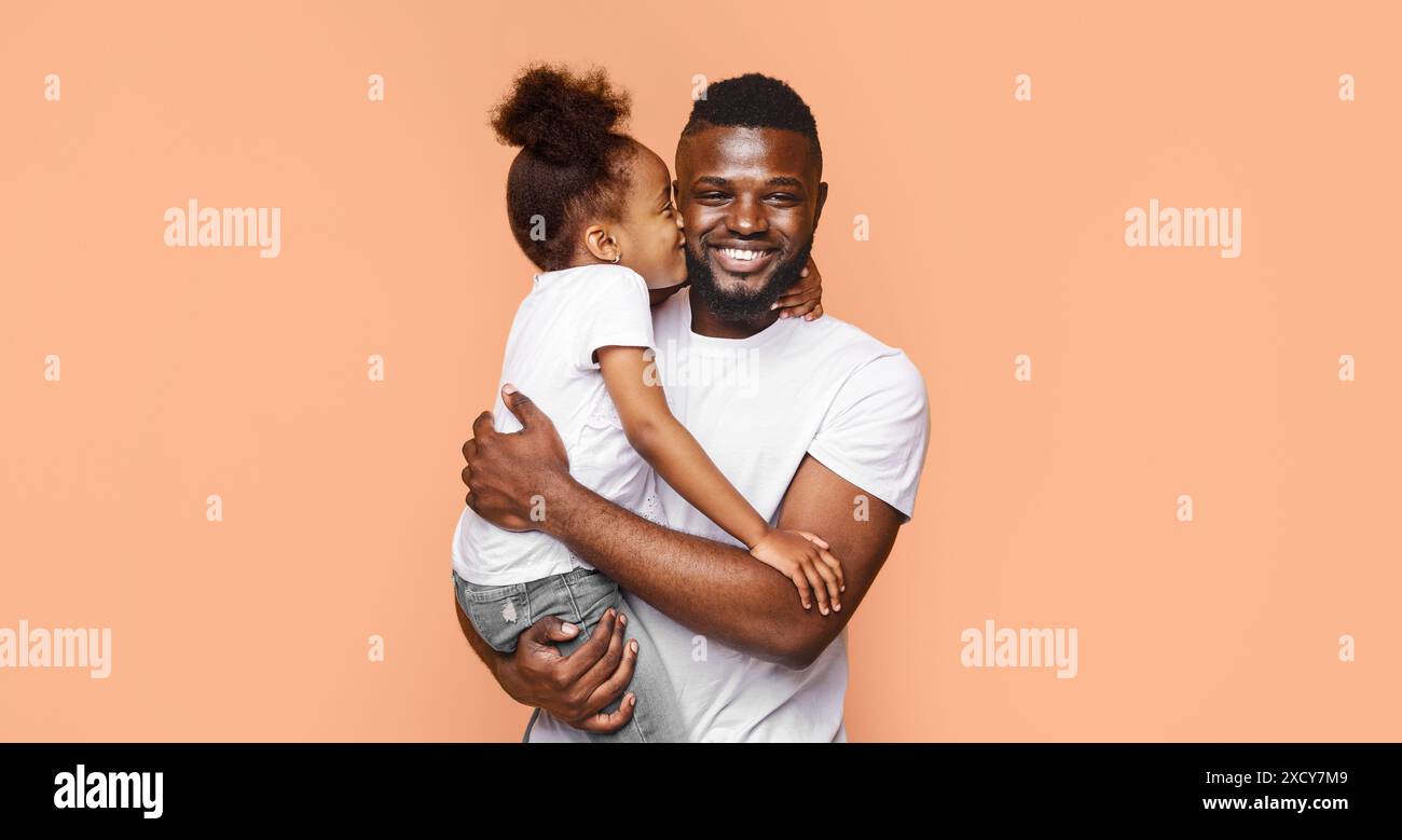 Happy Black Father Holding Daughter and Smiling Stock Photo - Alamy