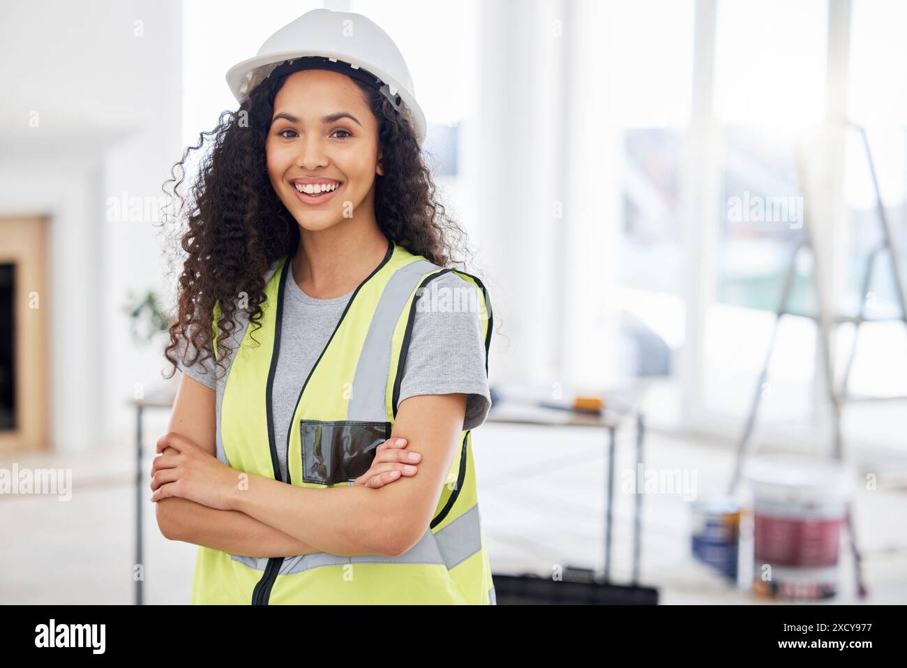 Happy portrait, arms crossed and woman in construction site for real ...