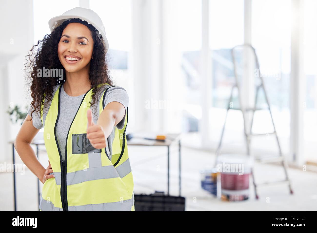 Thumbs up, woman and portrait on construction site for success ...