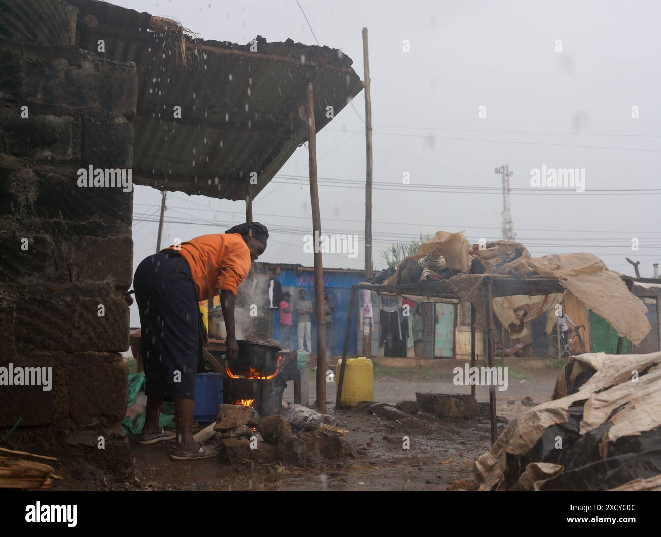 Woman cooking on a charcoal stove in Kibera slum Nairobi Kenya Stock ...